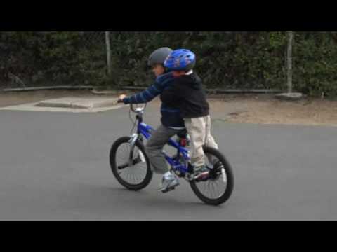 Gabriel riding bike with Matthew on pegs - YouTube