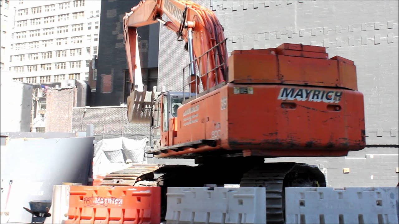 Hitachi ZX800 Triple Boom Excavator Loading Peterbilt Dump Truck - YouTube