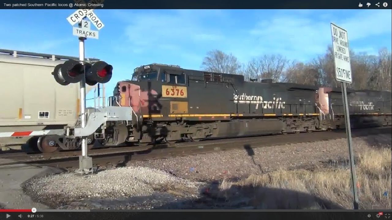 Two patched Southern Pacific locos pull UP freight @ Atomic Crossing ...