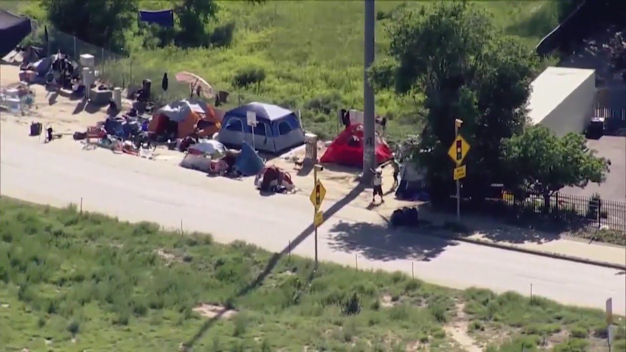 Encampment appears on shoulder of I-225 ramp - YouTube