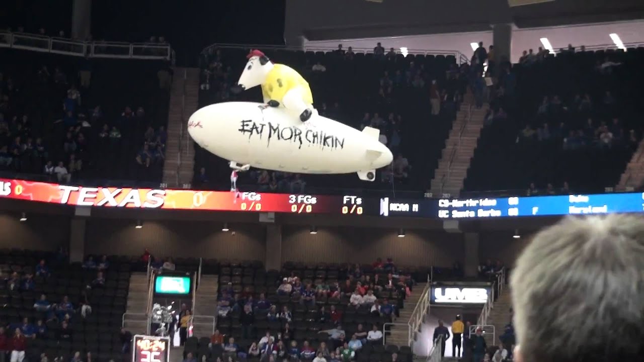 The Chick fil A Nylon blimp dropping parachutes to the crowd at the ...