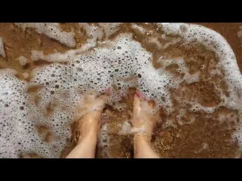 Bare Feet getting Wet on the Beach