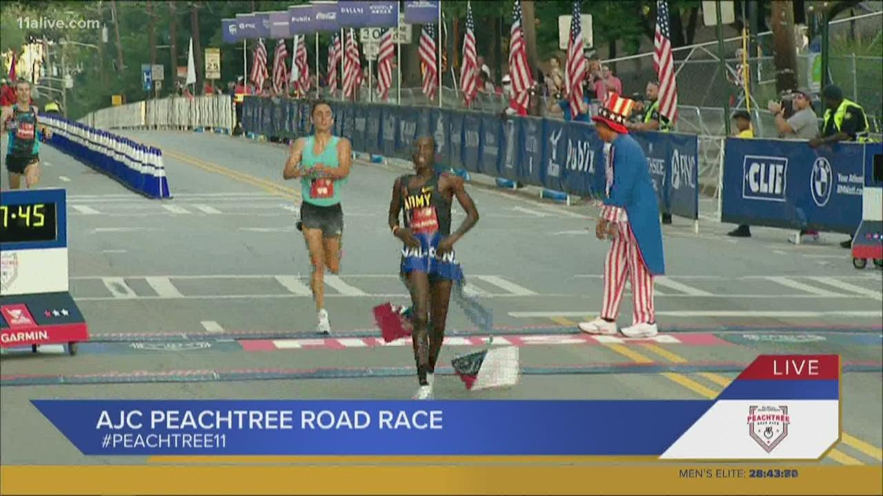 Sam Chelanga crosses the finish line as the winner of the men's elite ...