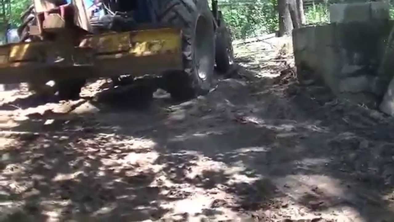 Clearing out brush and rocks to seed this field with grass - YouTube