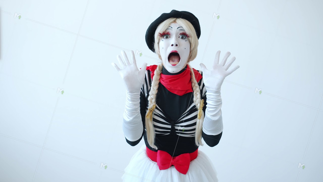 Slow motion portrait of young lady mime screaming and raising arms ...