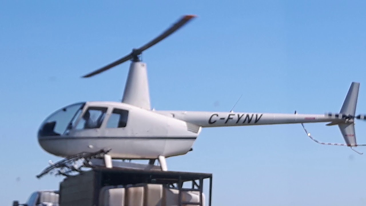 R44 helicopter Spraying field - YouTube