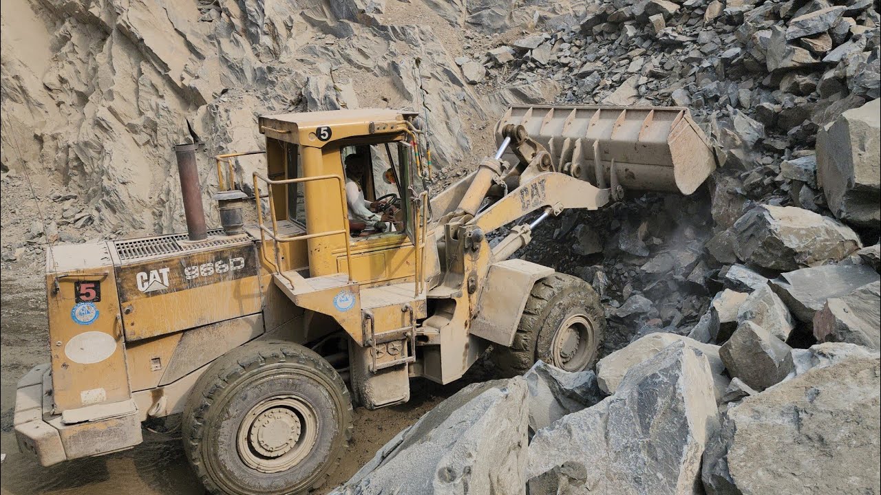 Heavy-duty Rock Loading Machine: Caterpillar 966D loading Rocks into ...