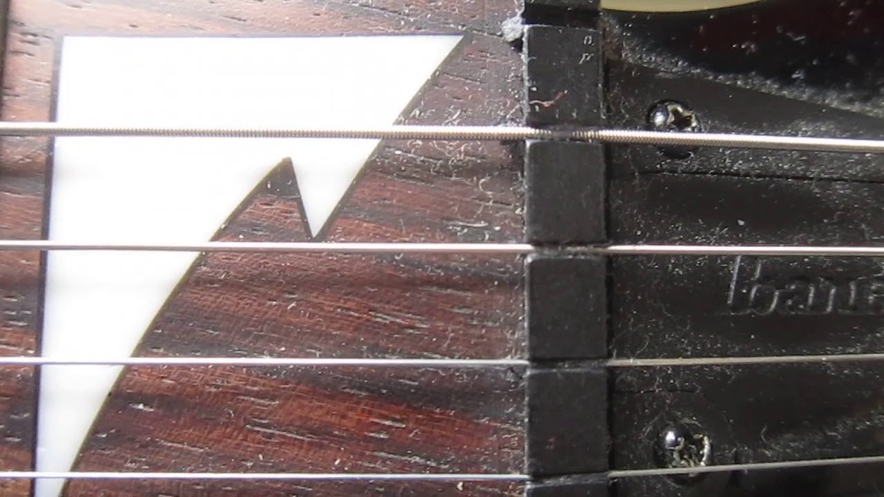 Guitar strings moving through guitar nut {a close-up} - YouTube