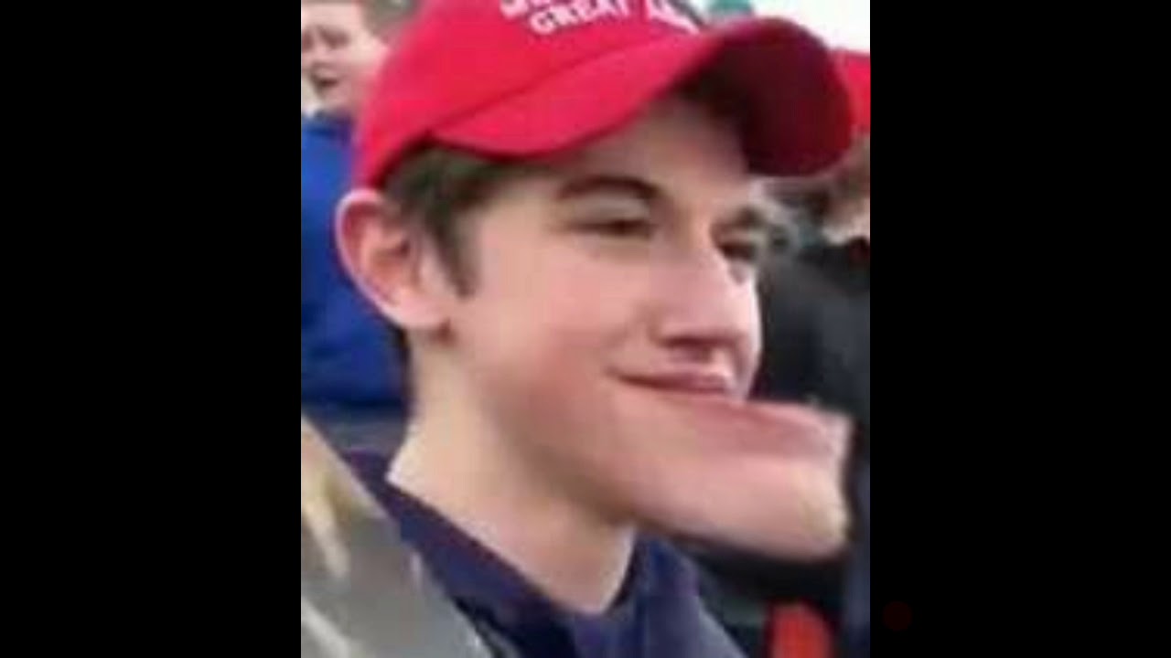Maga hat wearing teen almost hit on his chin. - YouTube