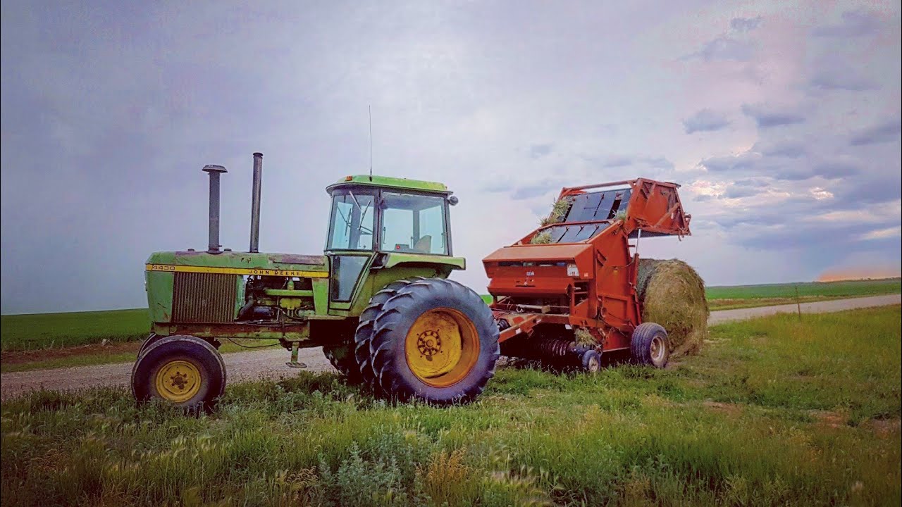 Baling hay racing the rains!! - YouTube