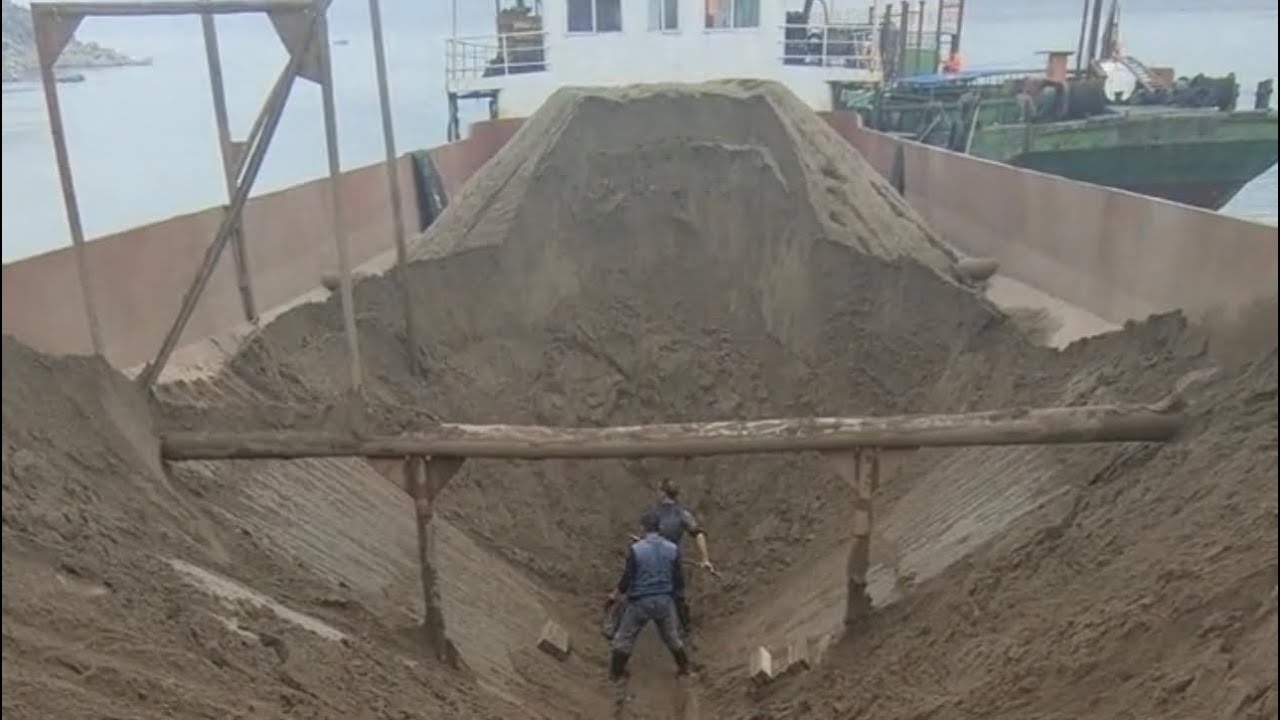 Barge unloads river sand. The workers work hard - YouTube