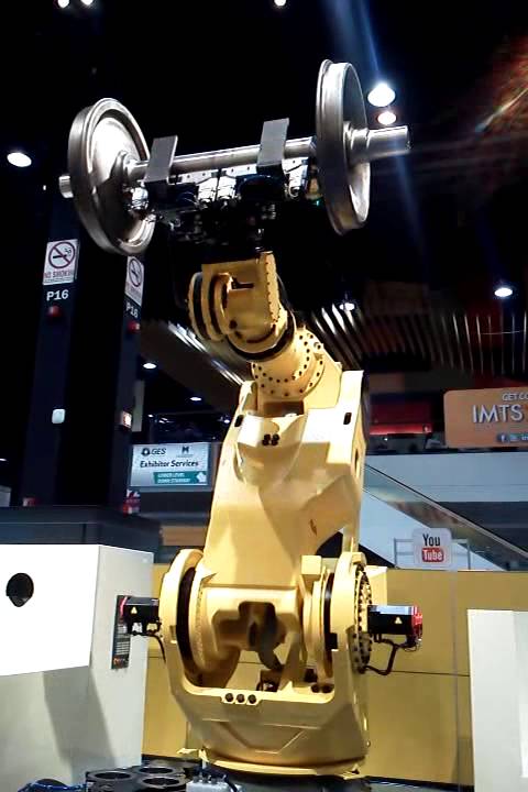 Fanuc robot lifts train axle and wheels - YouTube