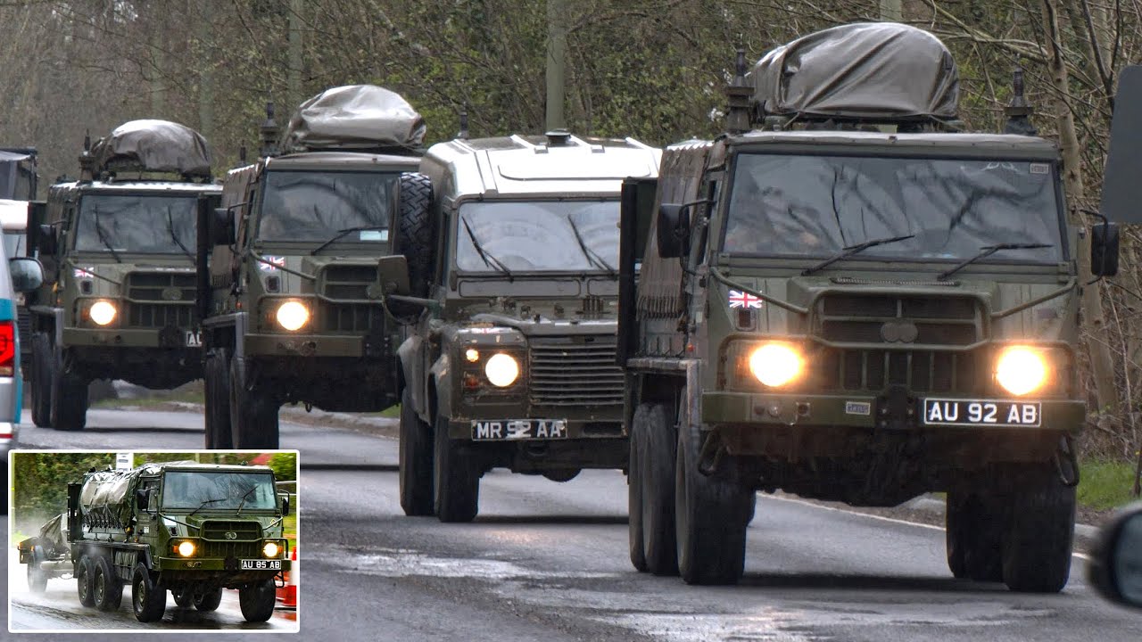 British Army trucks pulling field guns and travelling in utility ...