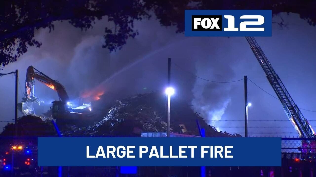Crews battle large pallet fire in North Portland - YouTube