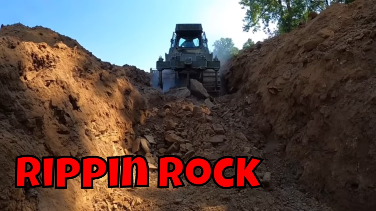 Ripping rock and hard dirt on the lake job with the 850j dozer and ...