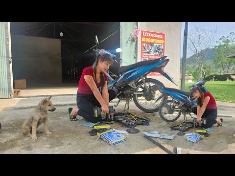 The girl took shelter under an umbrella to change the chain and sprockets on her motorbike.