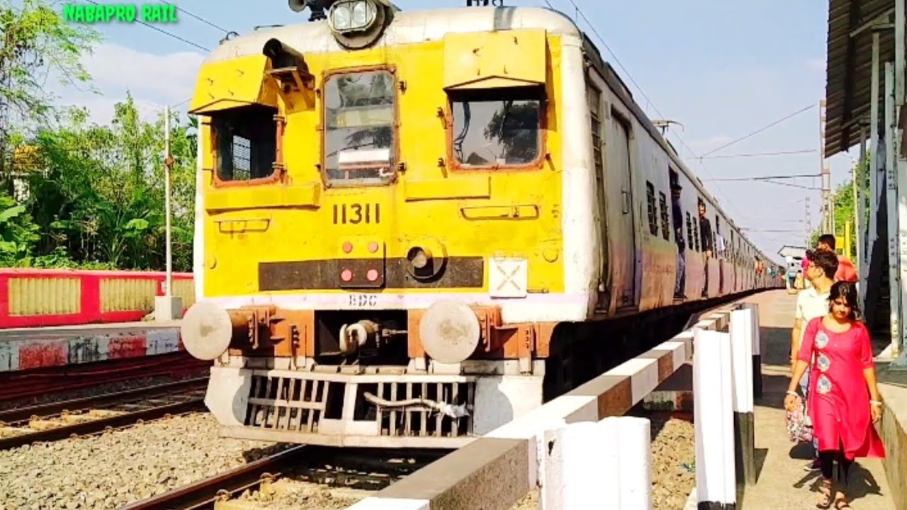 The train is going through the beautiful environment//lron barricade is ...