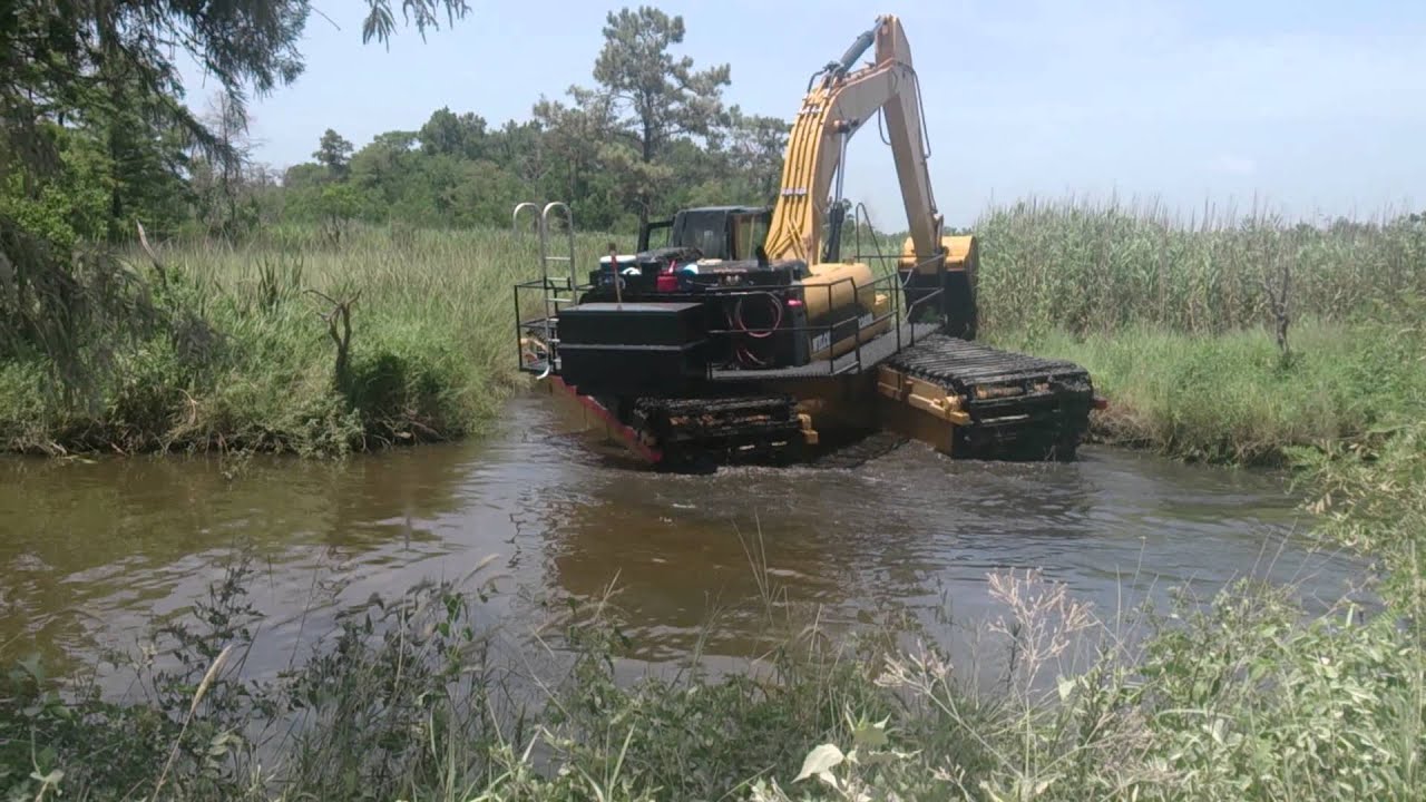 Marsh Track Hoe diving off into the Marsh - YouTube