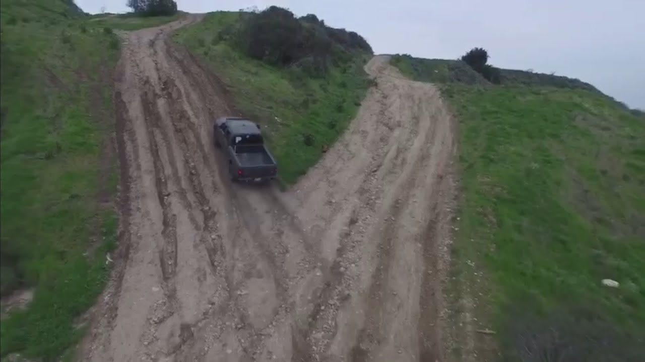 Drone footage of an F250 doing a hill climb - YouTube