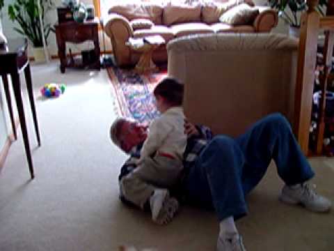 grandpa and grandson laughing and tickling with partner in crime Maggie dog.