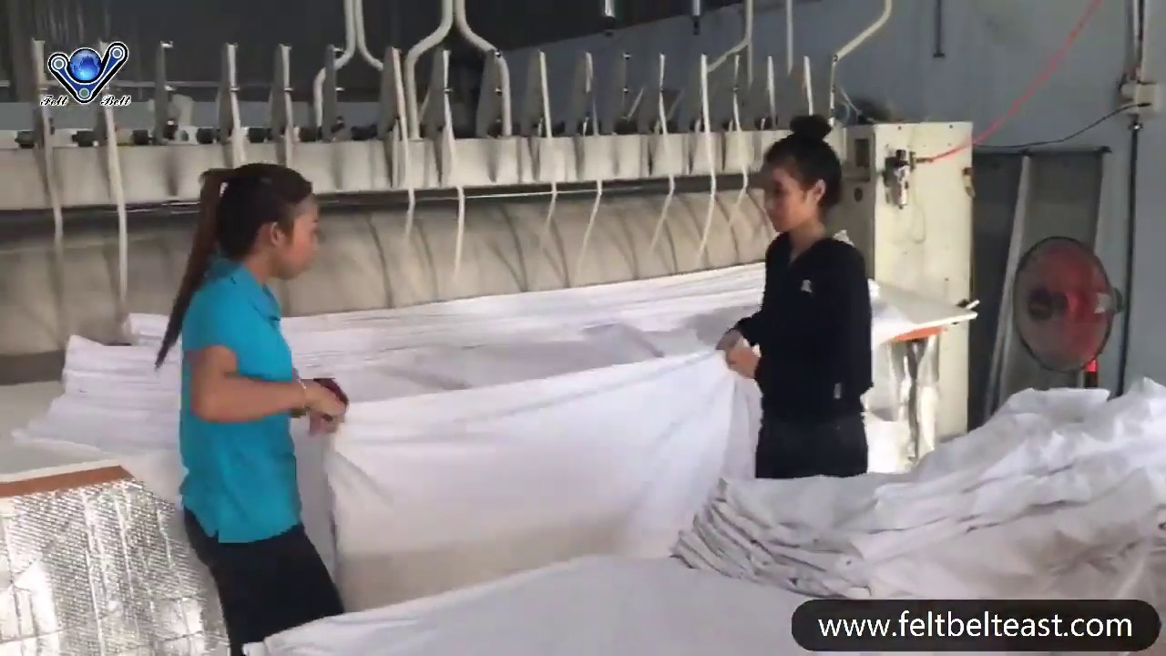 Flatwork ironer commercial laundry folding working - YouTube