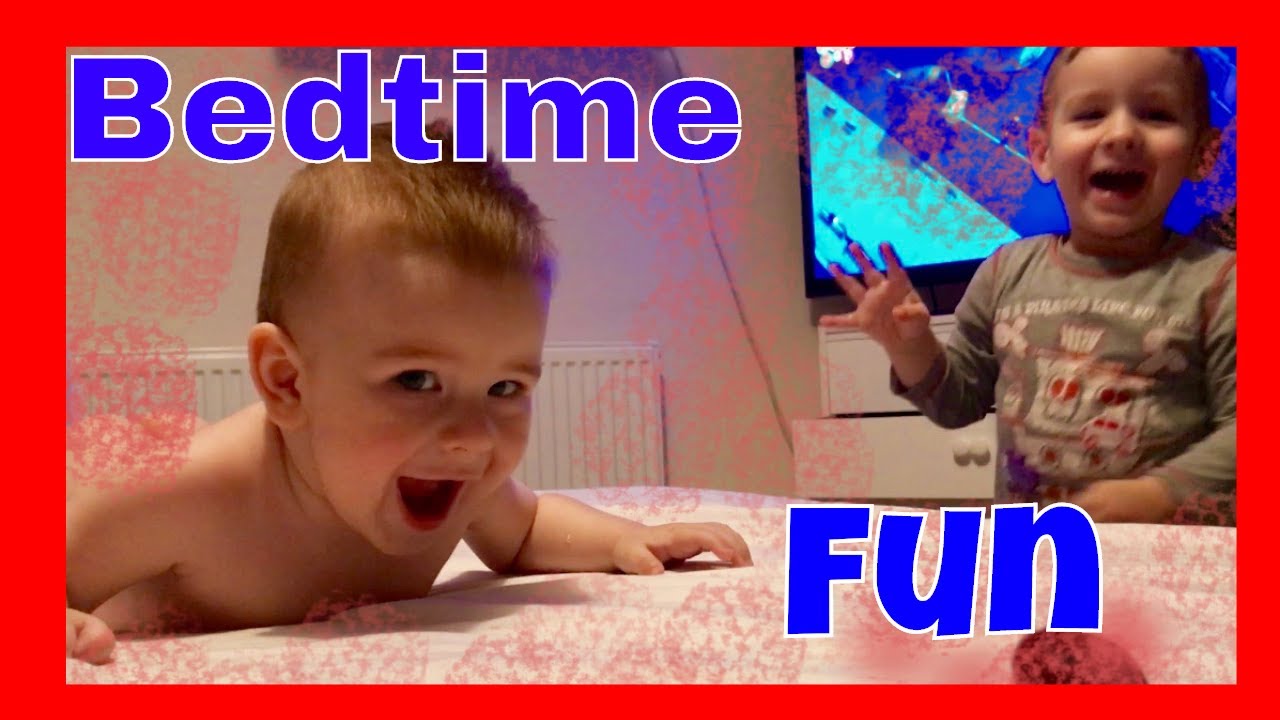 Toddler and baby bedtime fun. Brothers tickling each other. Babies ...