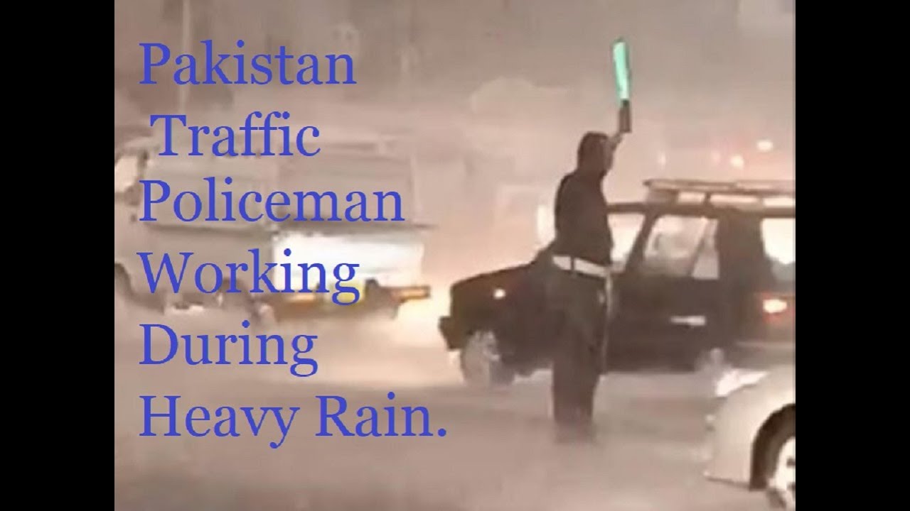 Pakistani traffic policeman working hard in heavy rain. - YouTube