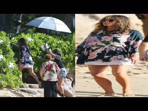 Jennifer Aniston showcases her defined legs in white mini skirt and floral wrap top as she films Mur