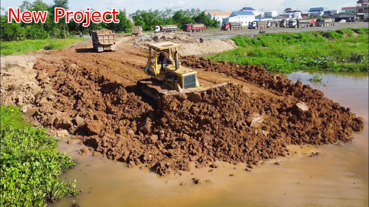 New road construction techniques by Komatsu bulldozer operator pushing ...