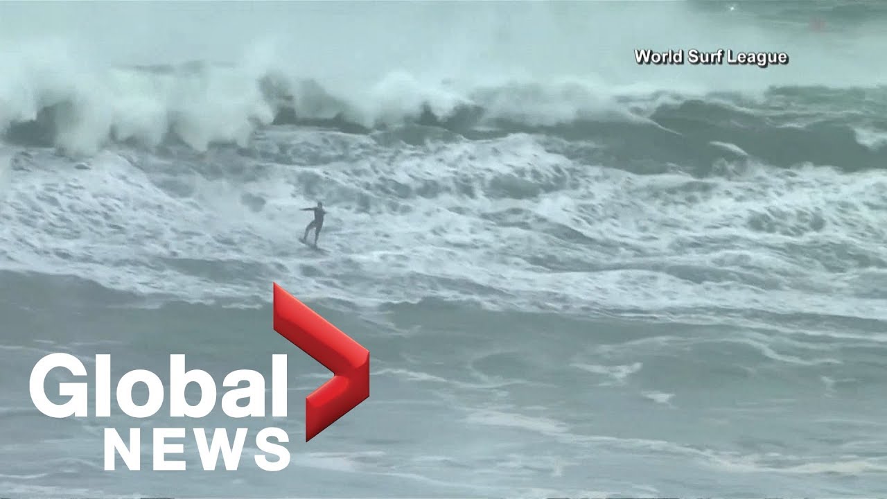 World's top surfers brave 50+ foot waves in Portugal's Praia do Norte ...