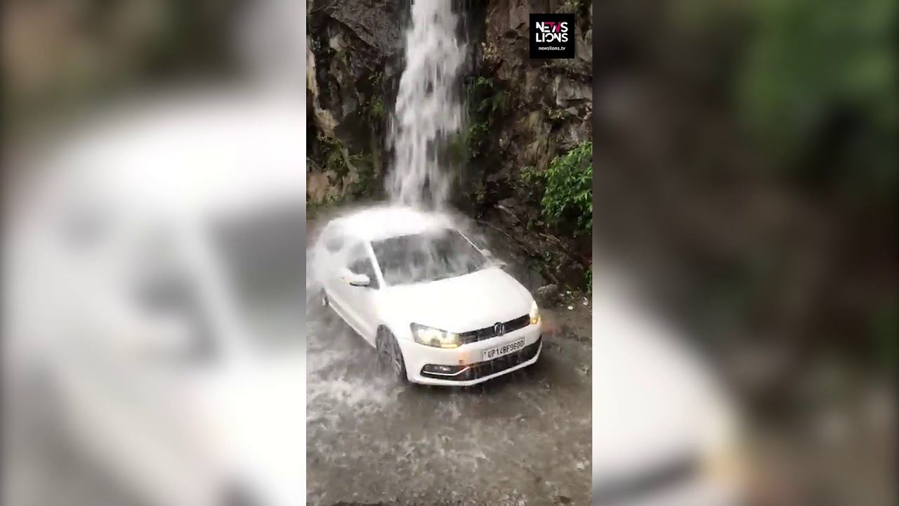 Fascinating video shows man driving car under waterfall to clean ...