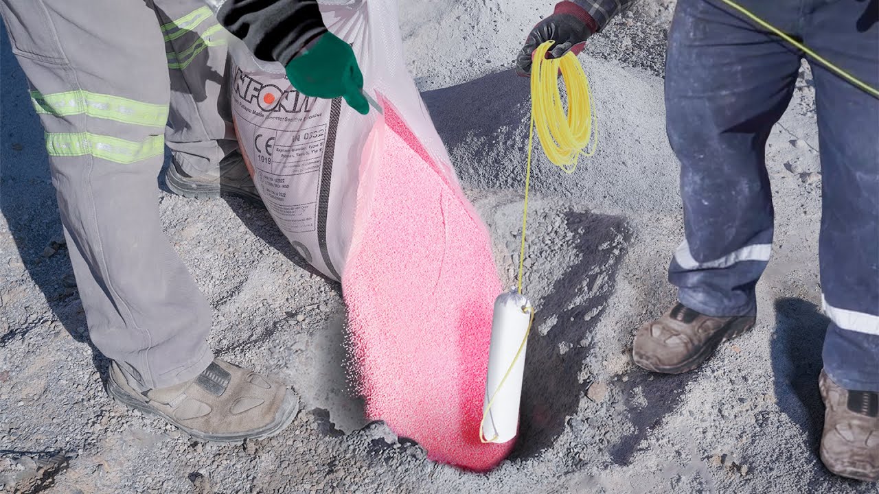 Skilled Mining Workers Pouring Special Pink Mixture Into Deep Hole ...