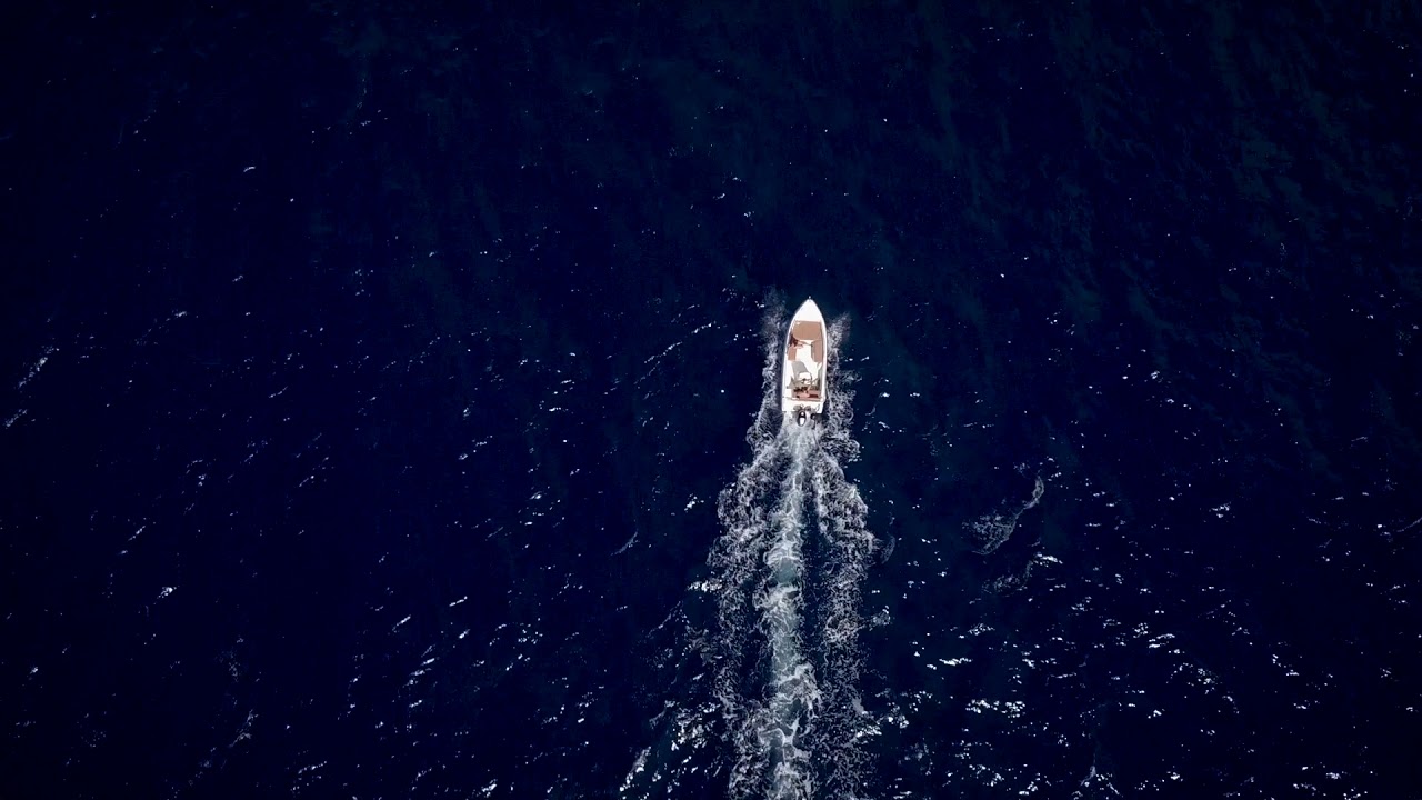 aerial view of a motor boat sailing the sea fast - YouTube