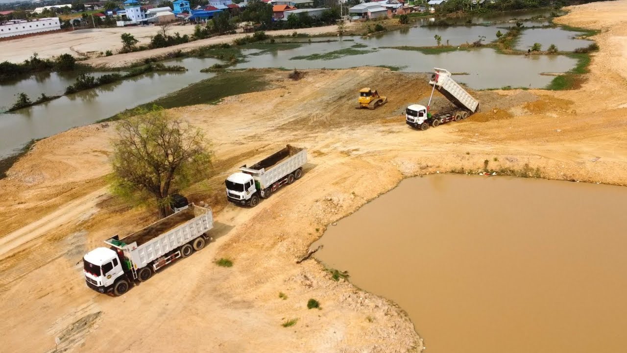 Excellent Techniques operator Dozer working push Dirt into the mud for ...
