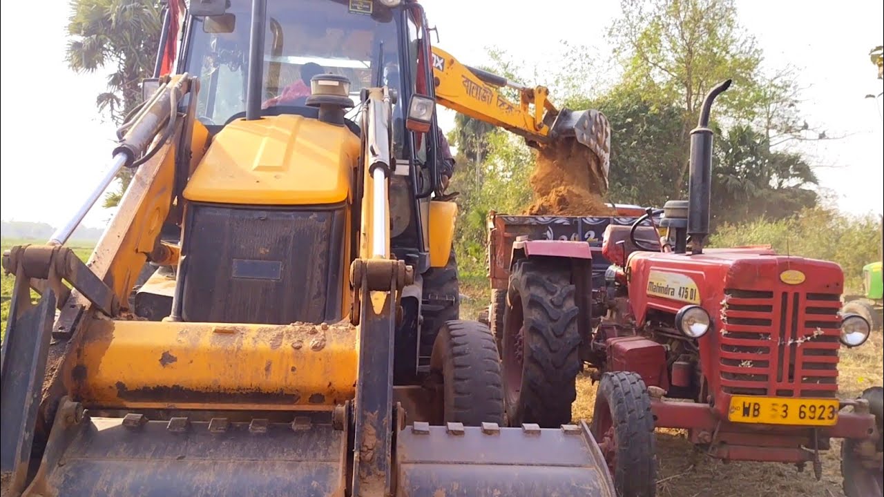 Jcb 3dx Backhoe Loader Machine Loading Red Mud In Mahindra 475 DI ...