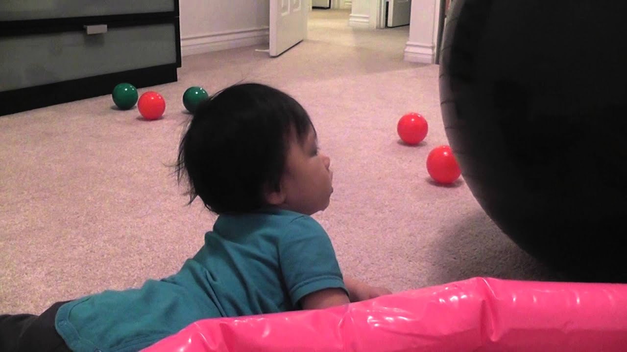 An Infant playing with an exercise ball - YouTube