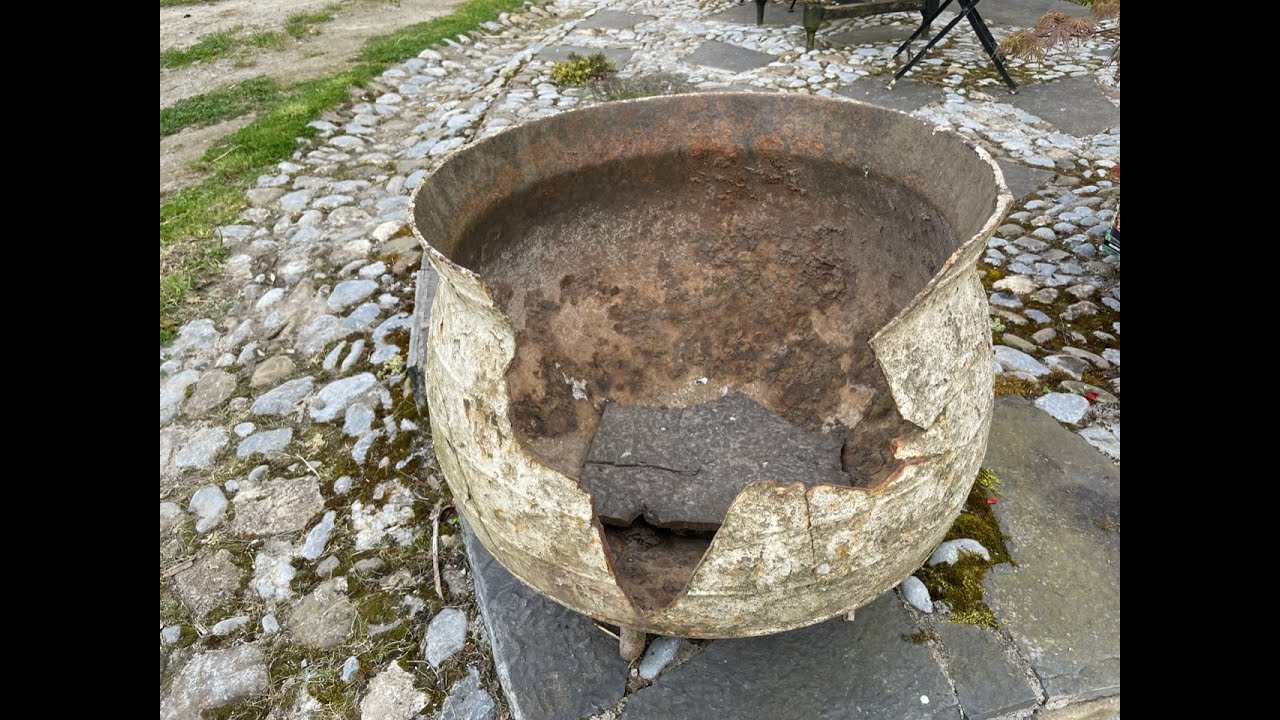 A big cracked old caldron with huge holes I turn into a floral planter ...