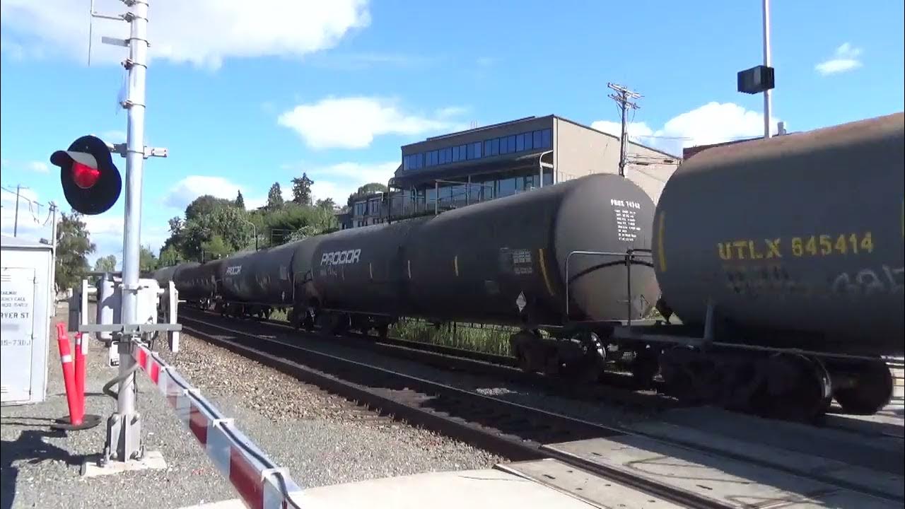 (Southbound) BNSF Mixed Freight Train passes through the McCarver Street Railroad Crossing ...