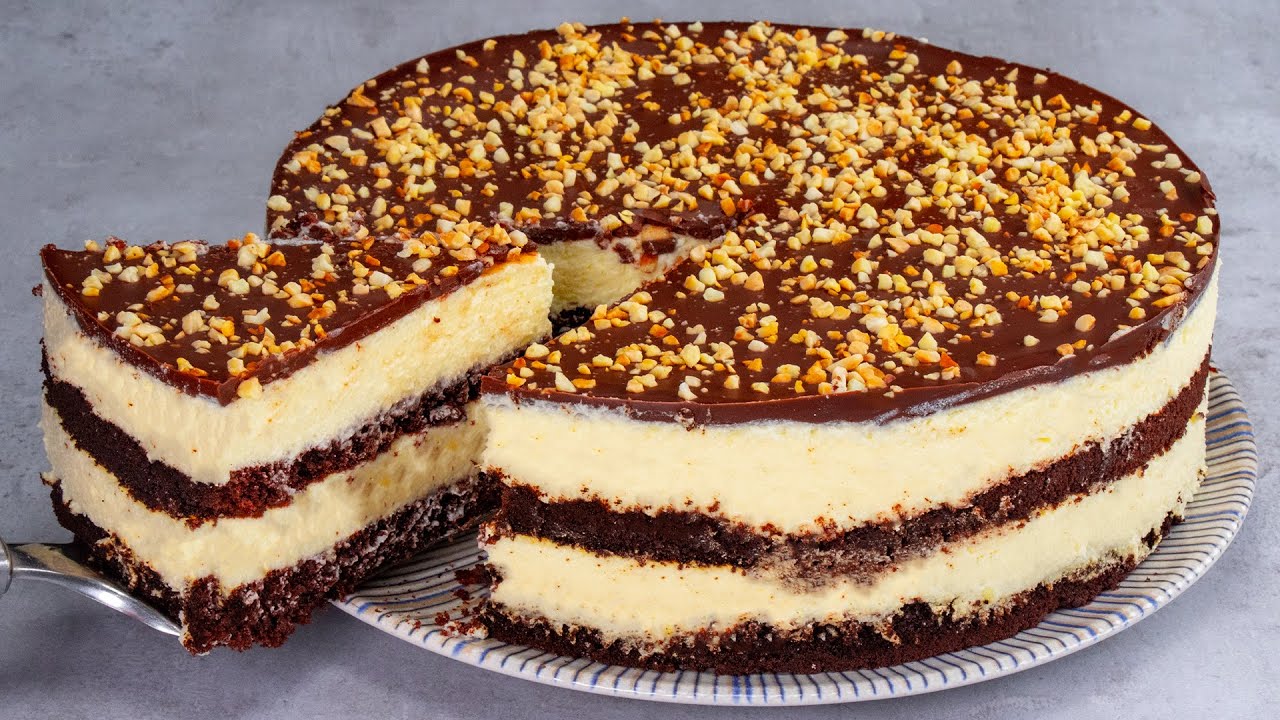 Cake with cocoa base and boiled cream. Sprinkle it with nuts to have a ...