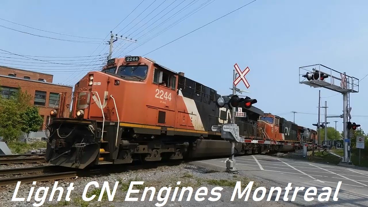 5 18 23 CN LIGHT ENGINES MOVE AT MONTREALS ST AMBROISE STREET CROSSING ...