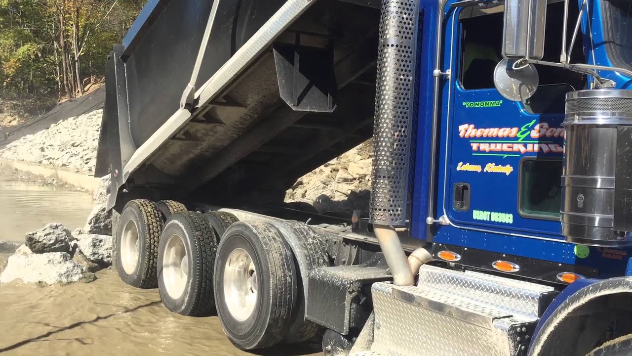 Dump truck dumping rip rap in a Creek! - YouTube