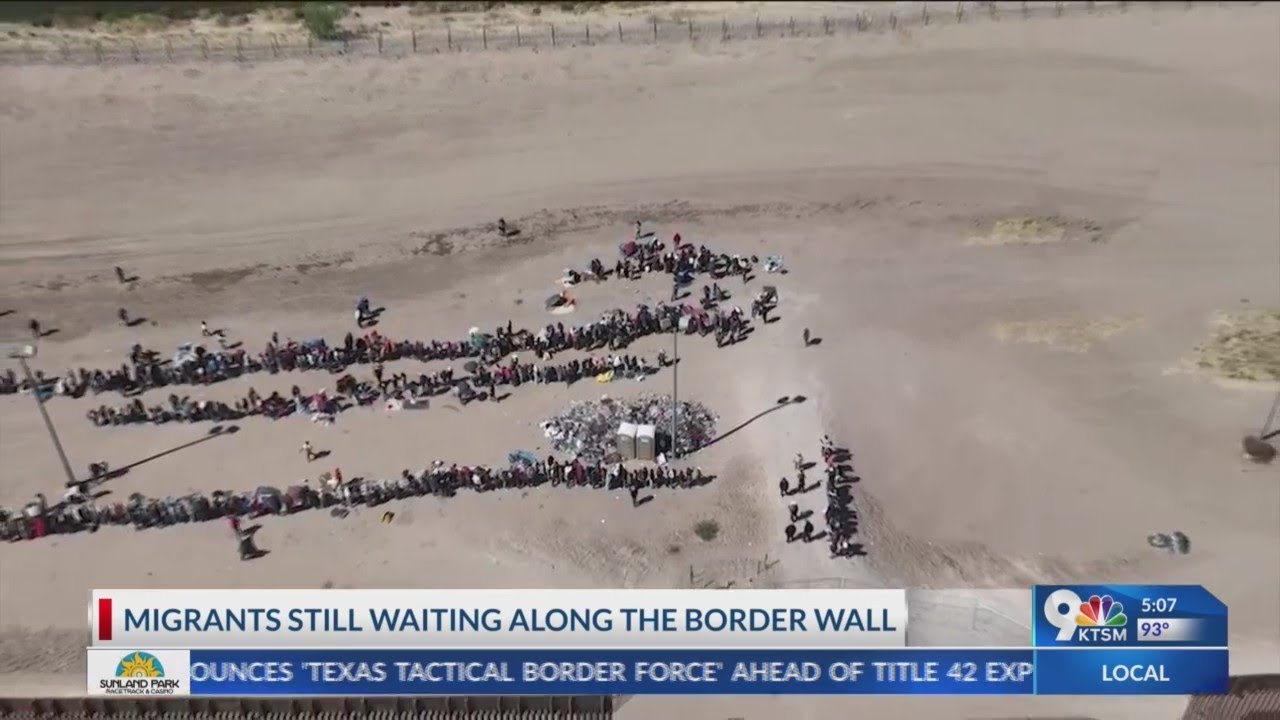 Migrants are still waiting along the border wall. - YouTube