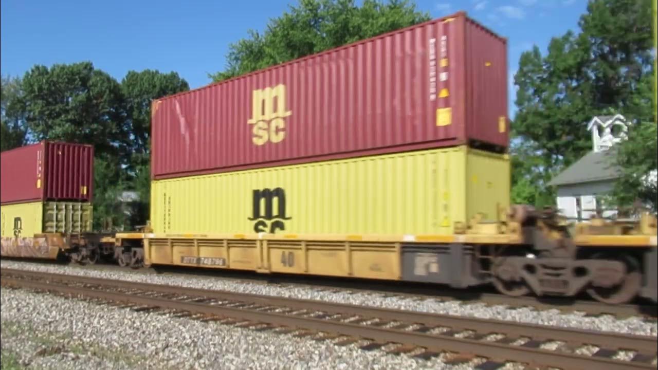 CN 2292, 8860 move a Westbound intermodal container in well car freight train at Vicksburg, MI ...
