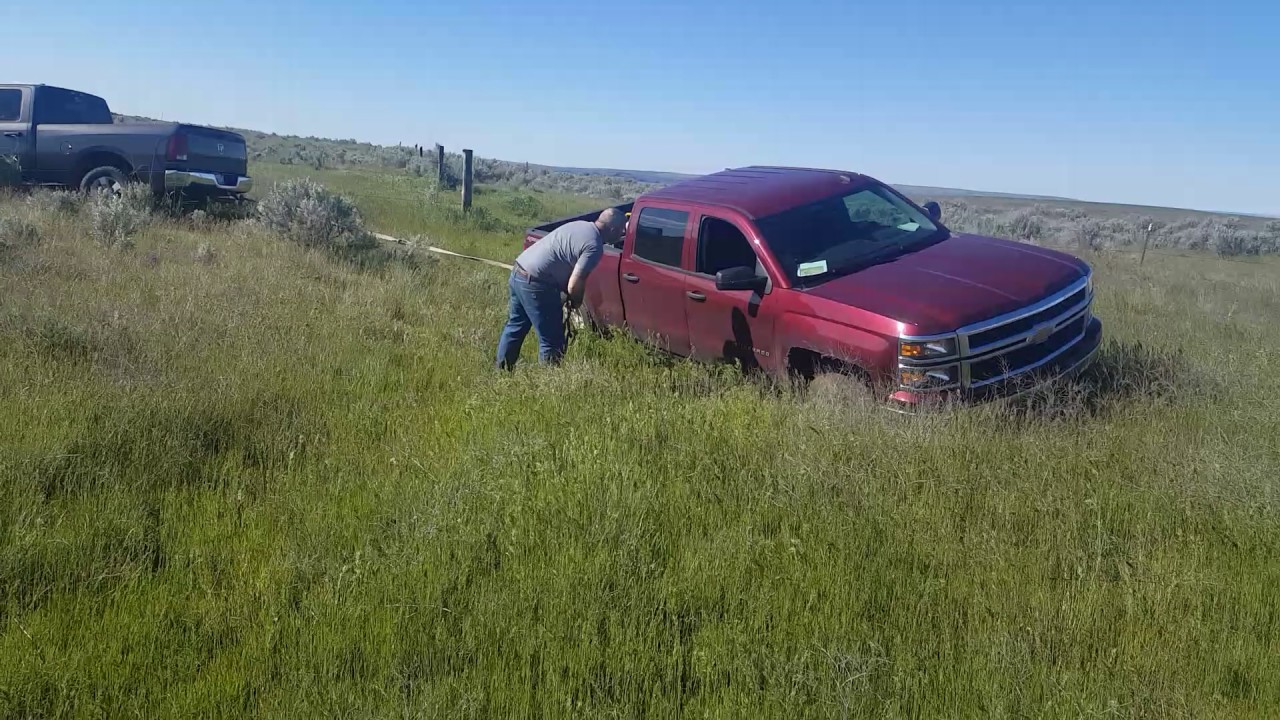 Ram 1500 pulls Chevy Silverado out of the mud! - YouTube