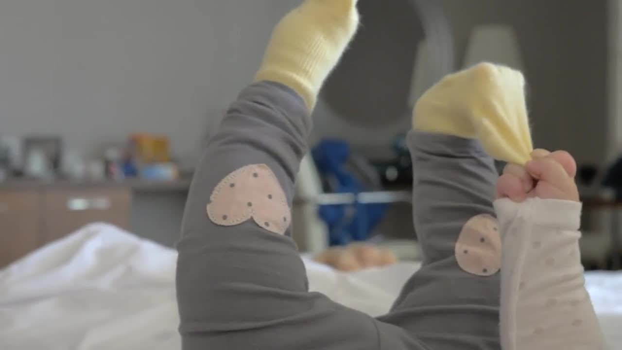 Baby Trying To Remove Socks Stock Video - YouTube