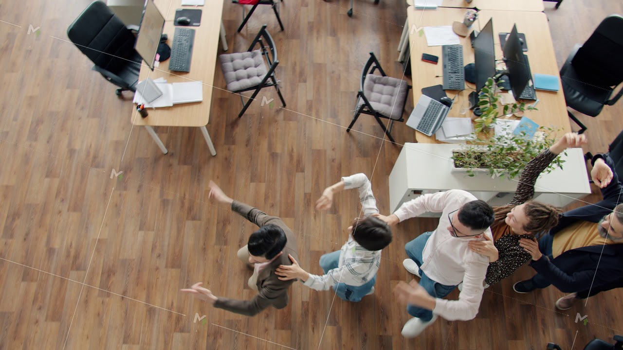 High angle view of joyful people office workers dancing in modern open ...