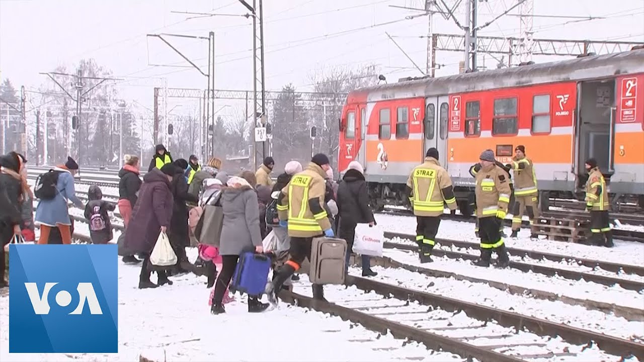 Refugees Fleeing Ukraine Board Train in Poland - YouTube