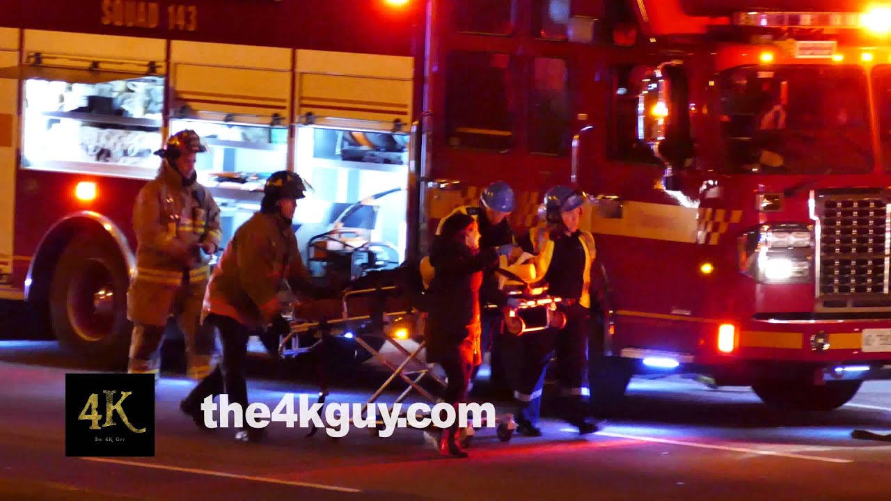 4K UHD - Emergency team carrying stretcher while doing CPR on car crash ...