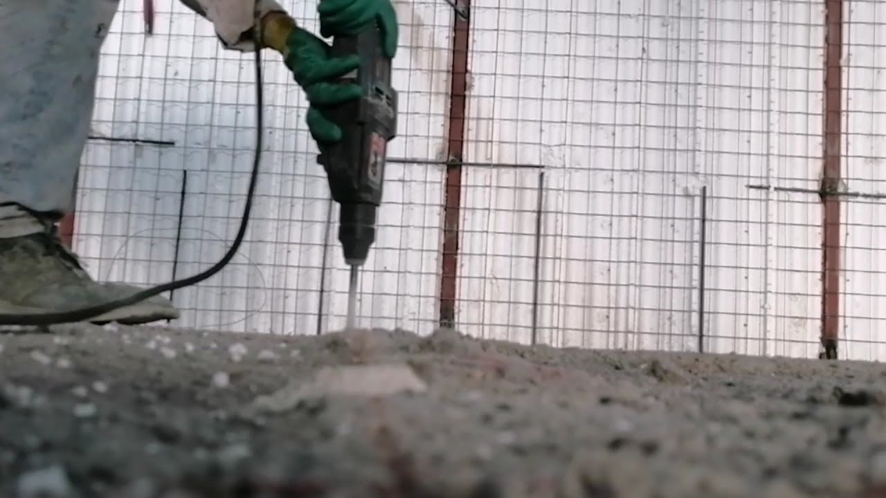 Drilling holes with a drill and installing precast 3D wall panels ...