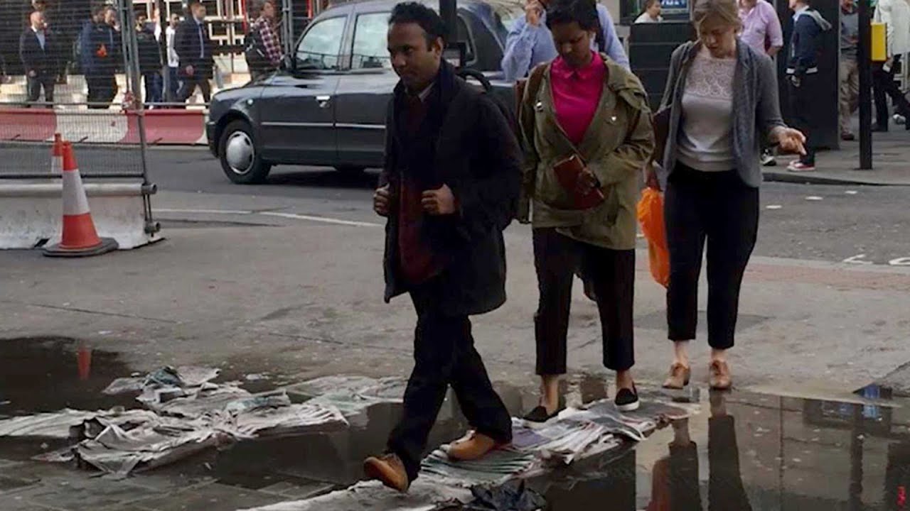 Commuters Make Mini Newspaper Bridge - YouTube